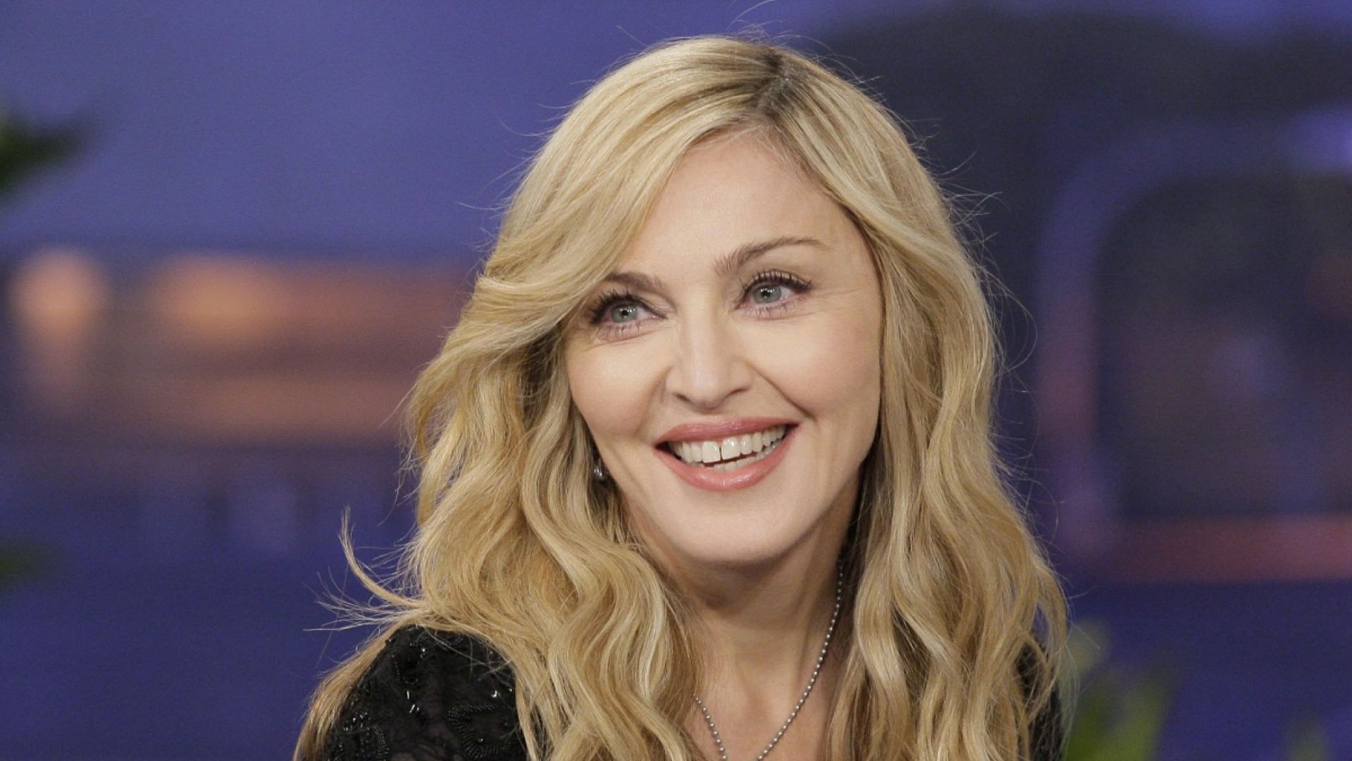 Madonna displays sensational figure in corseted mini dress and fishnets ...