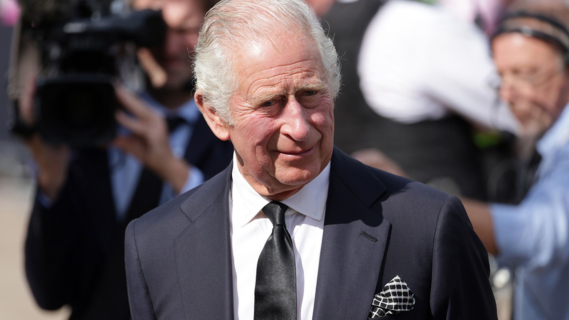 King Charles III looks so sombre as he views floral tributes to the ...