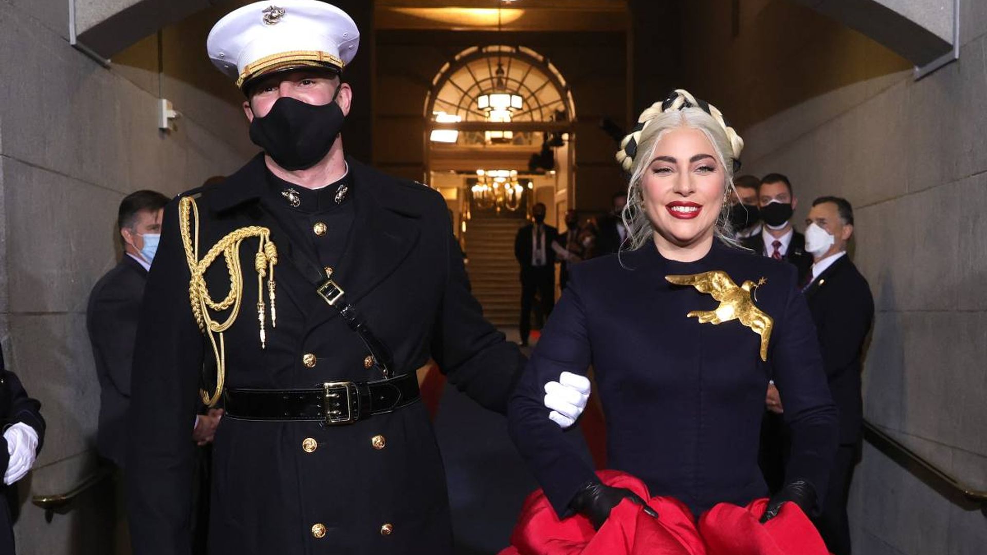 Lady Gaga surprises fans in a Hunger Games-esque dress at Joe Biden’s ...
