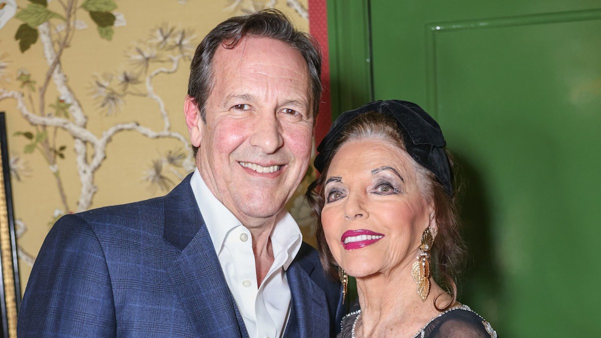 Joan Collins, 91, supported by besotted husband Percy in romantic ...