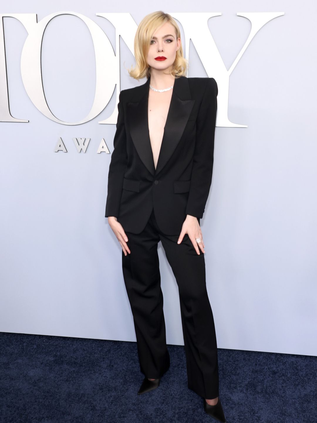 Elle Fanning's plunging black suit and red lip is giving major SHE-E-O ...