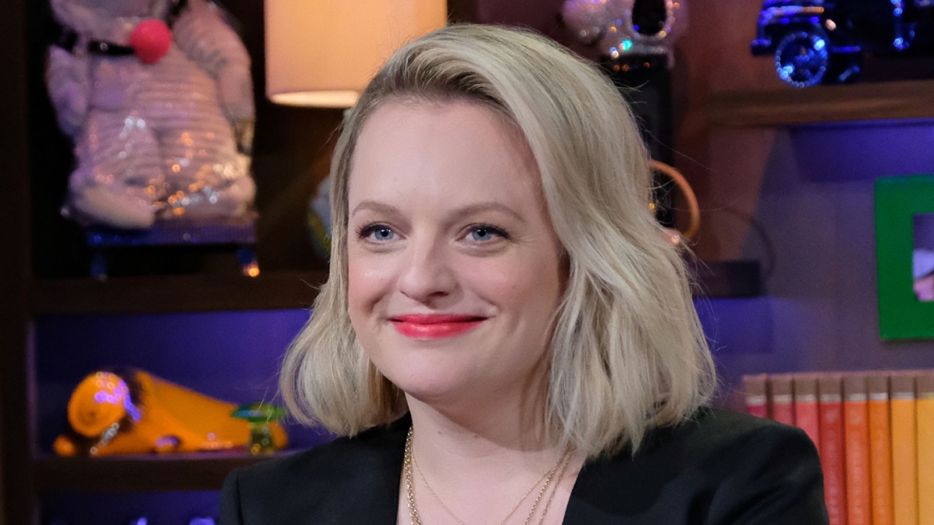 Elisabeth Moss turns heads in orange suit and bustier for divisive late ...