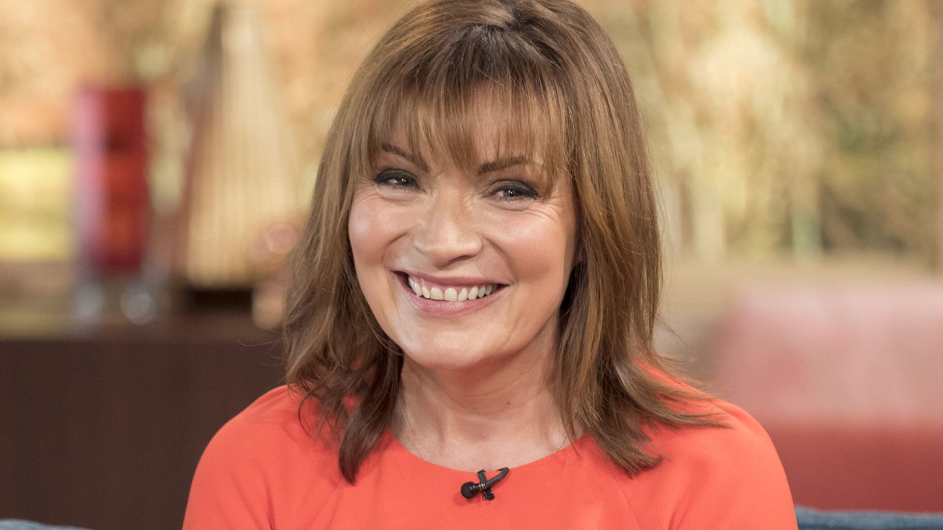 Lorraine Kelly looks a million pounds in bright orange statement dress ...