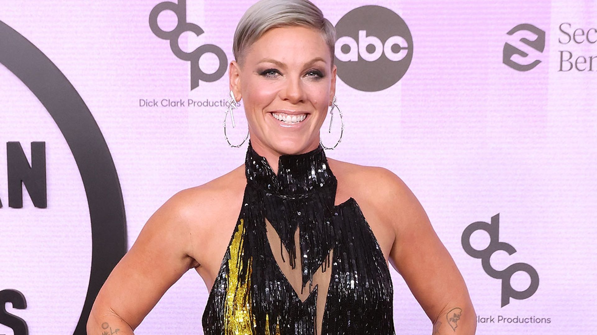 Pink displays her impressively toned physique in cut-out red swimsuit ...