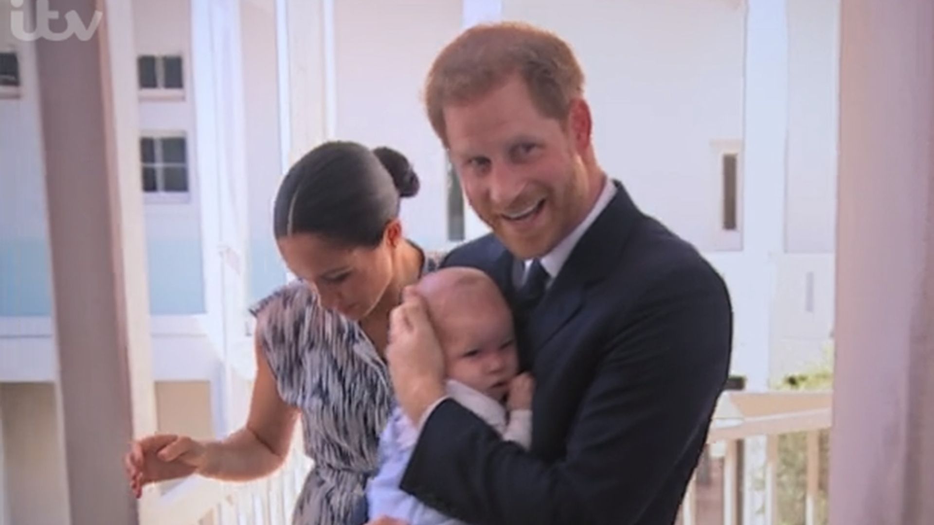 Prince Harry spotted rocking baby Archie in background of controversial ...