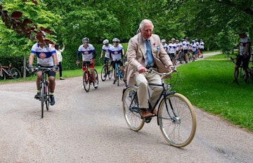 Prince Charles get the giggles as he rides a bicycle near his country ...