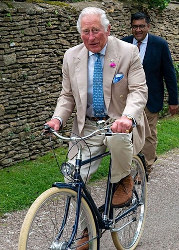 Prince Charles get the giggles as he rides a bicycle near his country ...