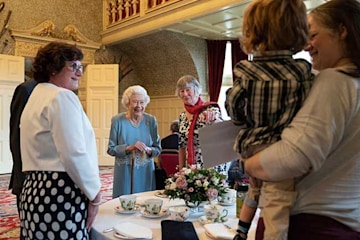 The Queen looks chic in blue to host celebratory tea party as she ...